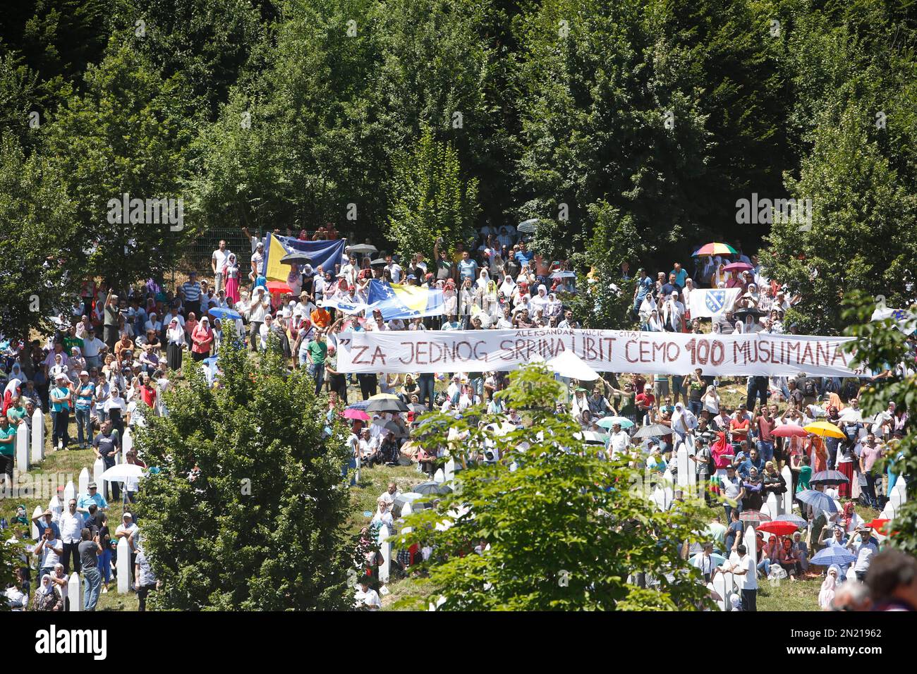 Bosnian Muslim people display a banner reading "For every killed Serb ...