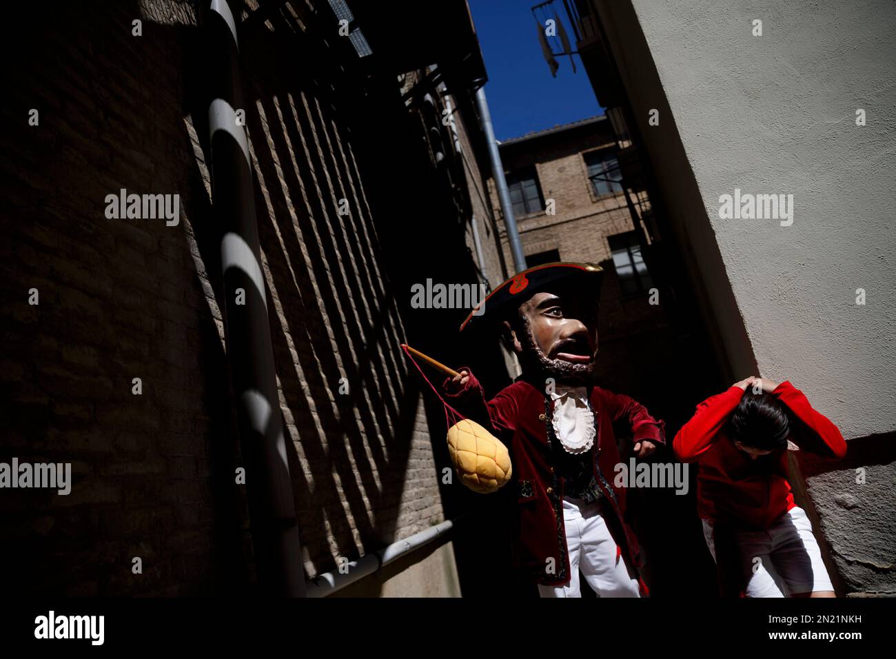 A 'Kiliki' or Big Head hits a girl as he takes part in the daily ...