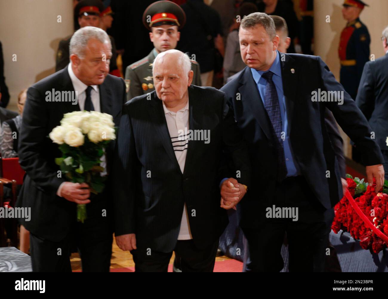 Former Soviet President Mikhail Gorbachev, center, walks after he paid ...