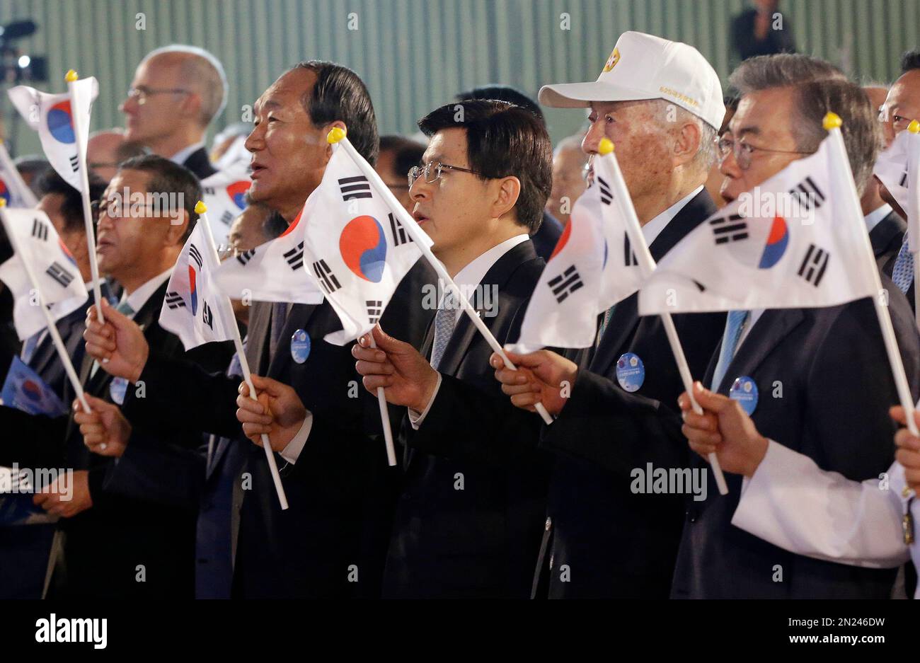 South Korea's Prime Minister Hwang Kyo-ahn, center, and participants ...