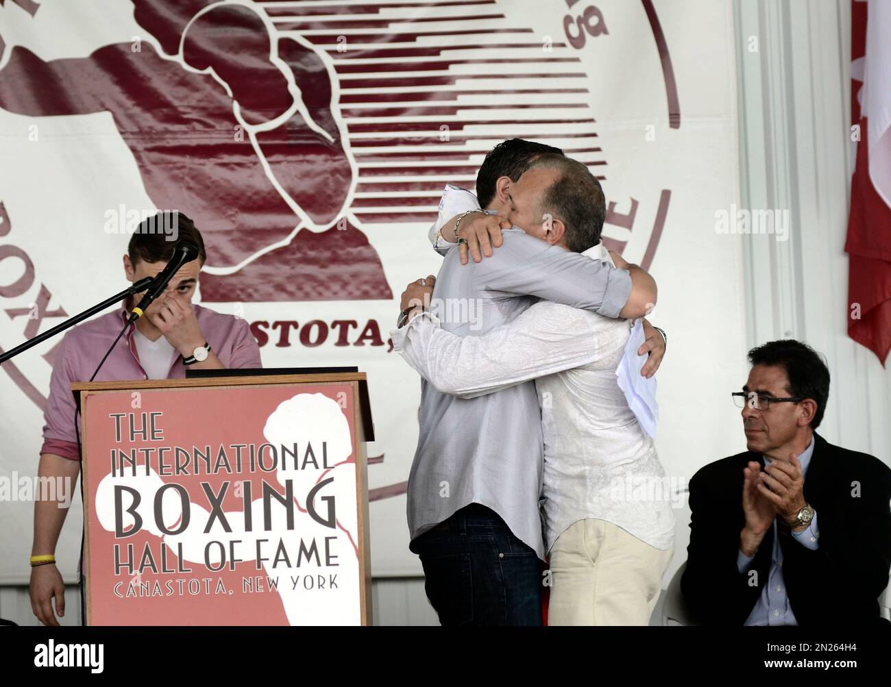 Leo Mancini, second from left, , hugs his father Ray Mancini, after ...