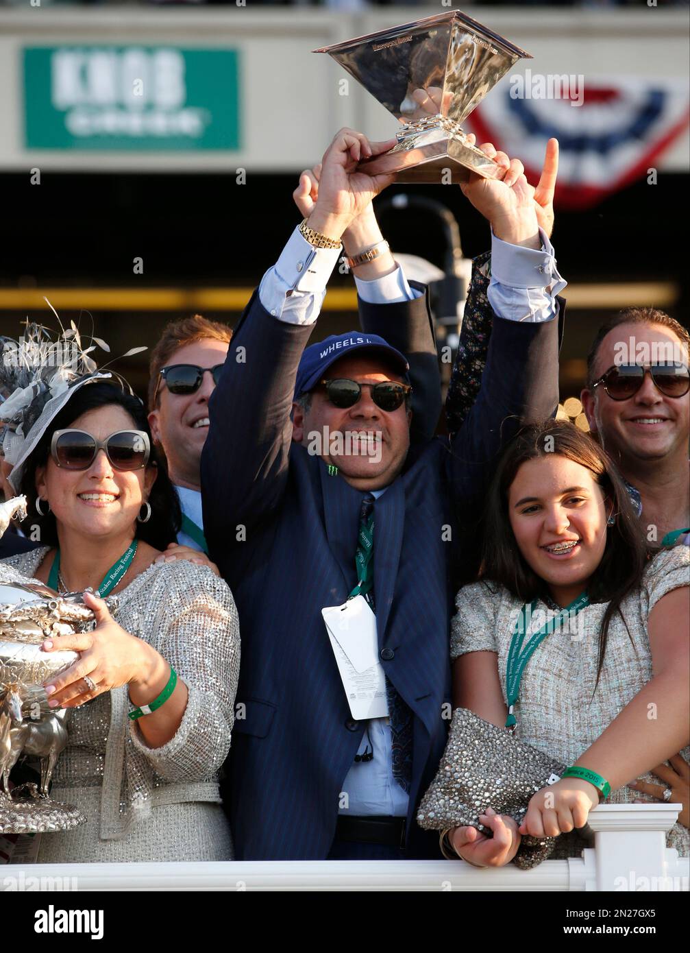 Ahmed Zayat, the owner of American Pharoah, holds up the Triple Crown ...