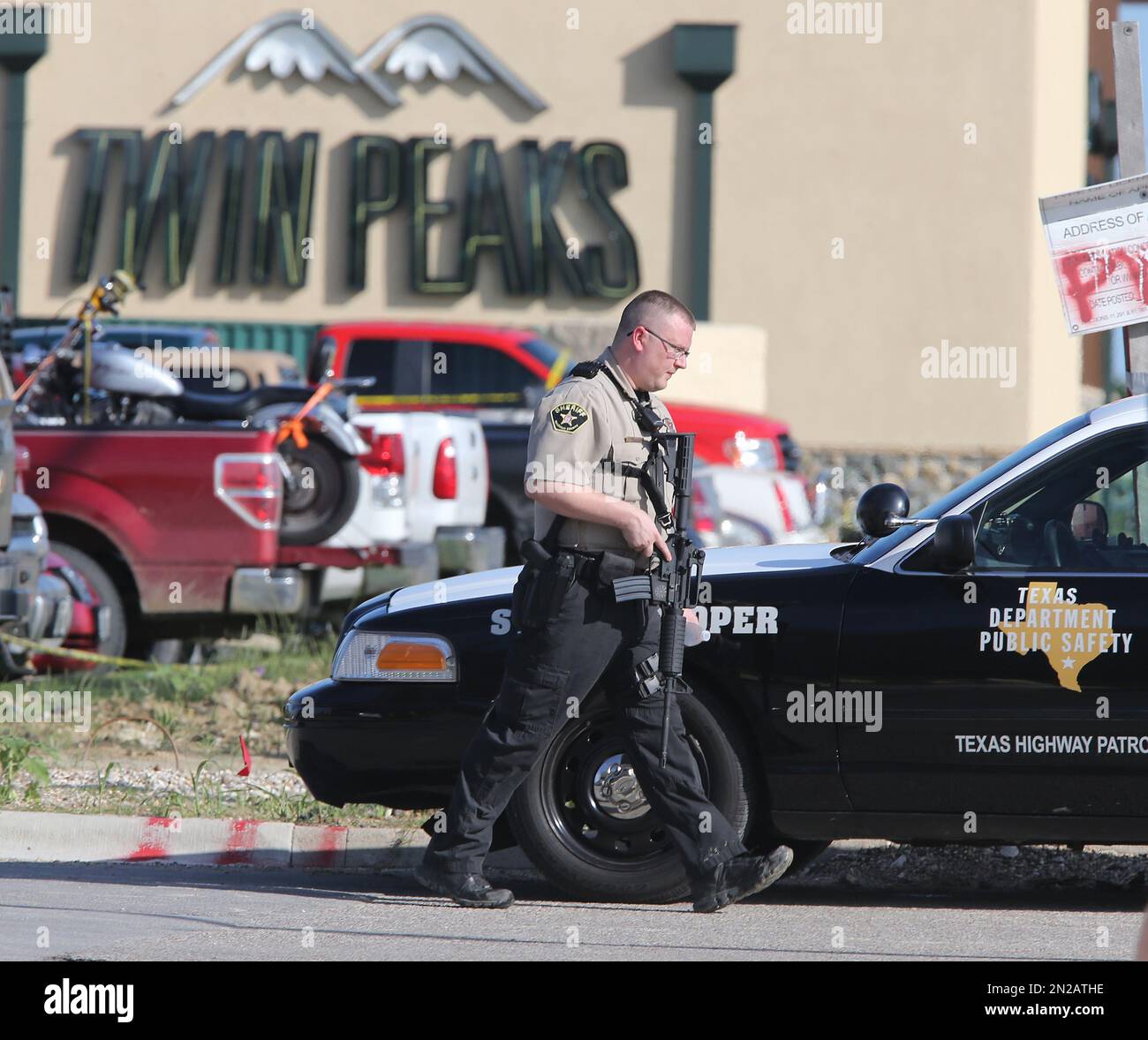 Authorities investigate a shooting in the parking lot of the Twin Peaks ...