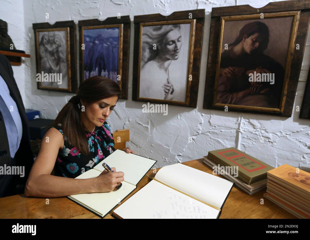 Mexican and American actress Salma Hayek signs the museum guest book ...