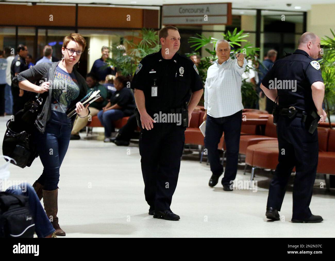 Officers guard the entrance to concourse A and B at the New Orleans ...
