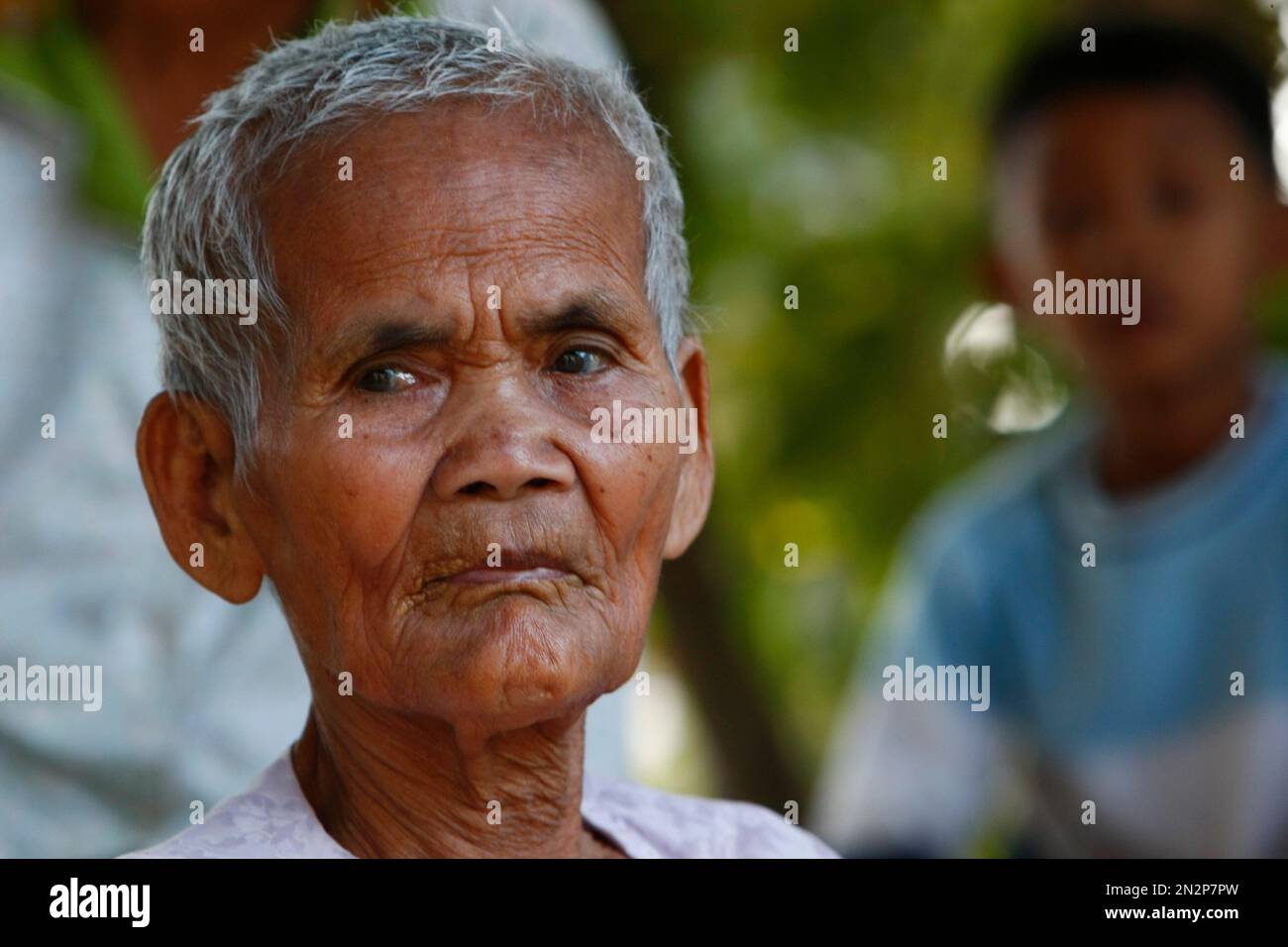 In this Feb. 2, 2015 photo, Samret Khut, aunt of Sam Somaly, sits outside her home at Khmut ...