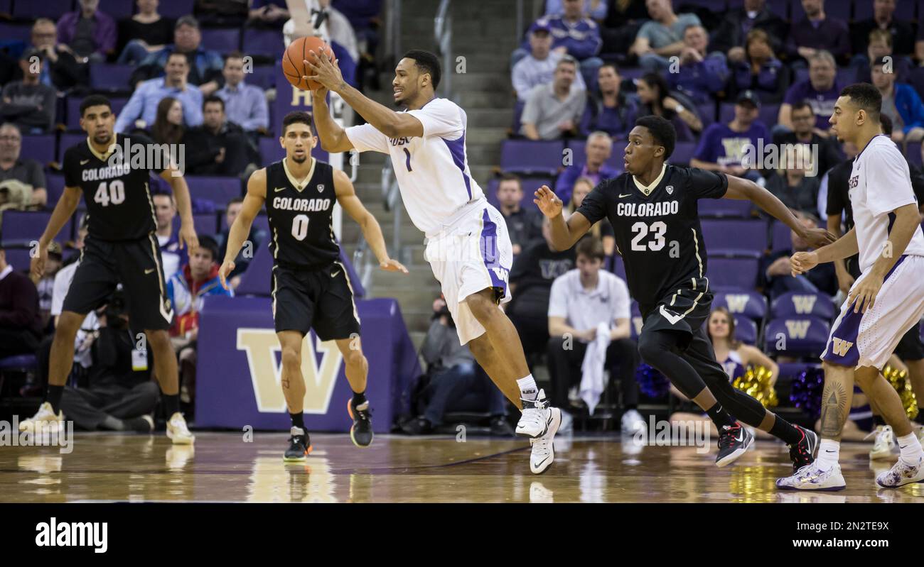 Washington's Darin Johnson, center, passes the ball as Colorado's Josh ...