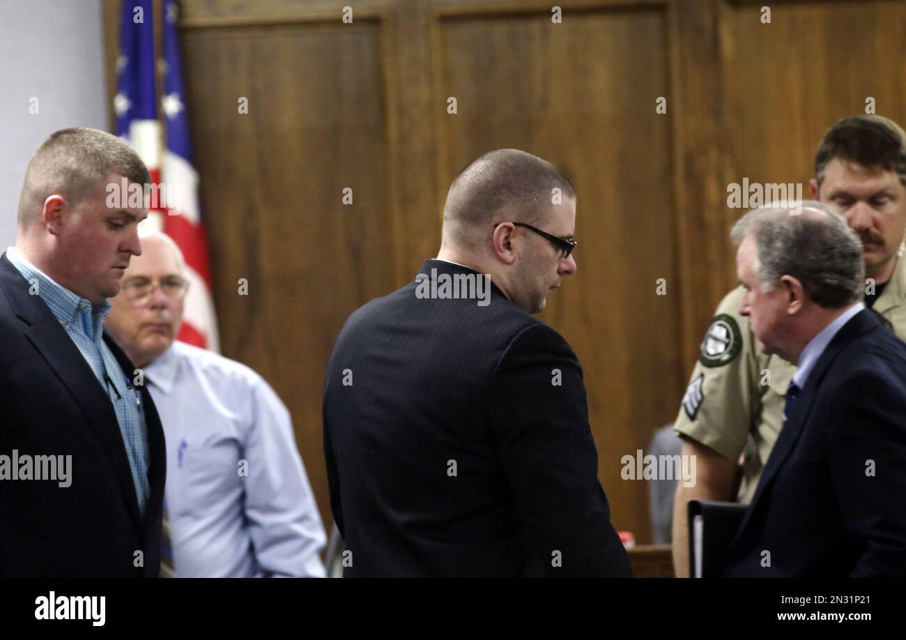 Eddie Ray Routh takes his seat in court, with law enforcement officers ...