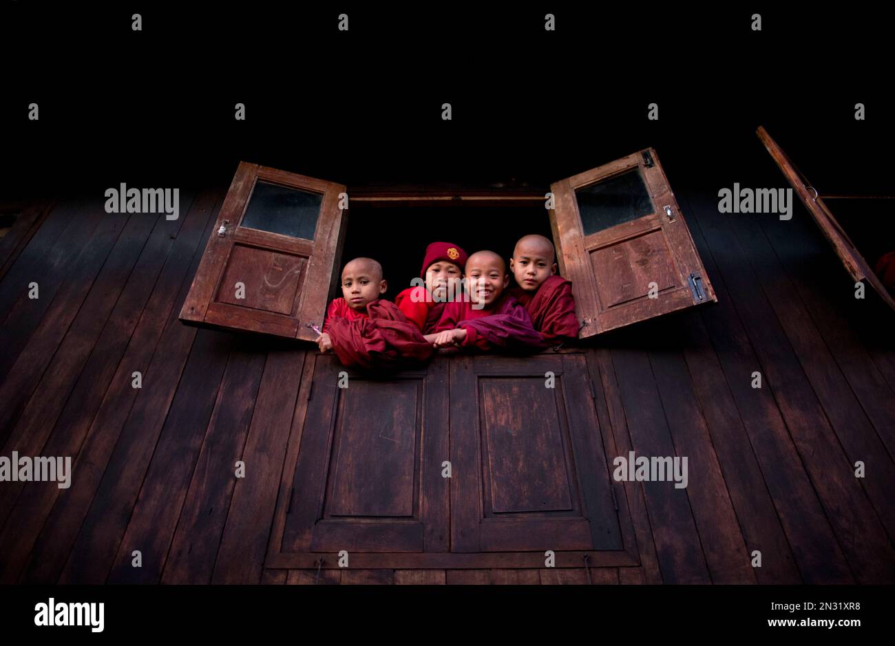 In this Jan. 11, 2015 photo, ethnic Ta'ang novice Buddhist monks peep ...