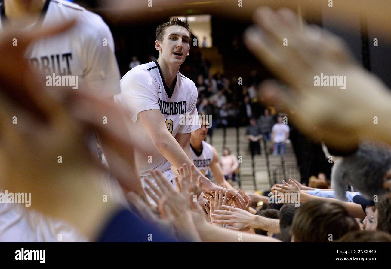 Vanderbilt forward Luke Kornet, center, slaps hands with fans as he ...