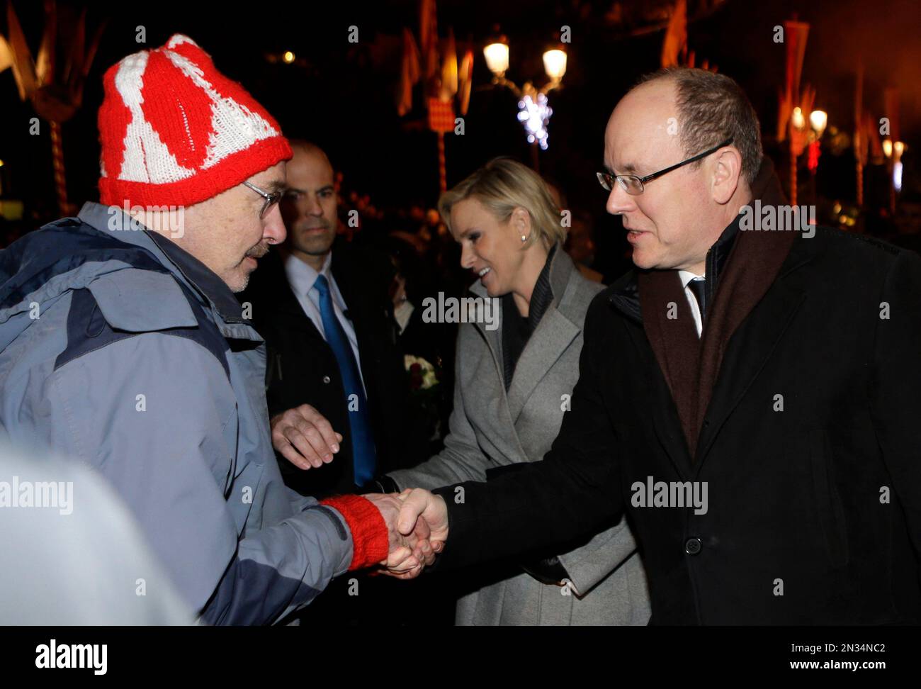 Prince Albert II of Monaco and his wife Princess Charlene shake hands ...