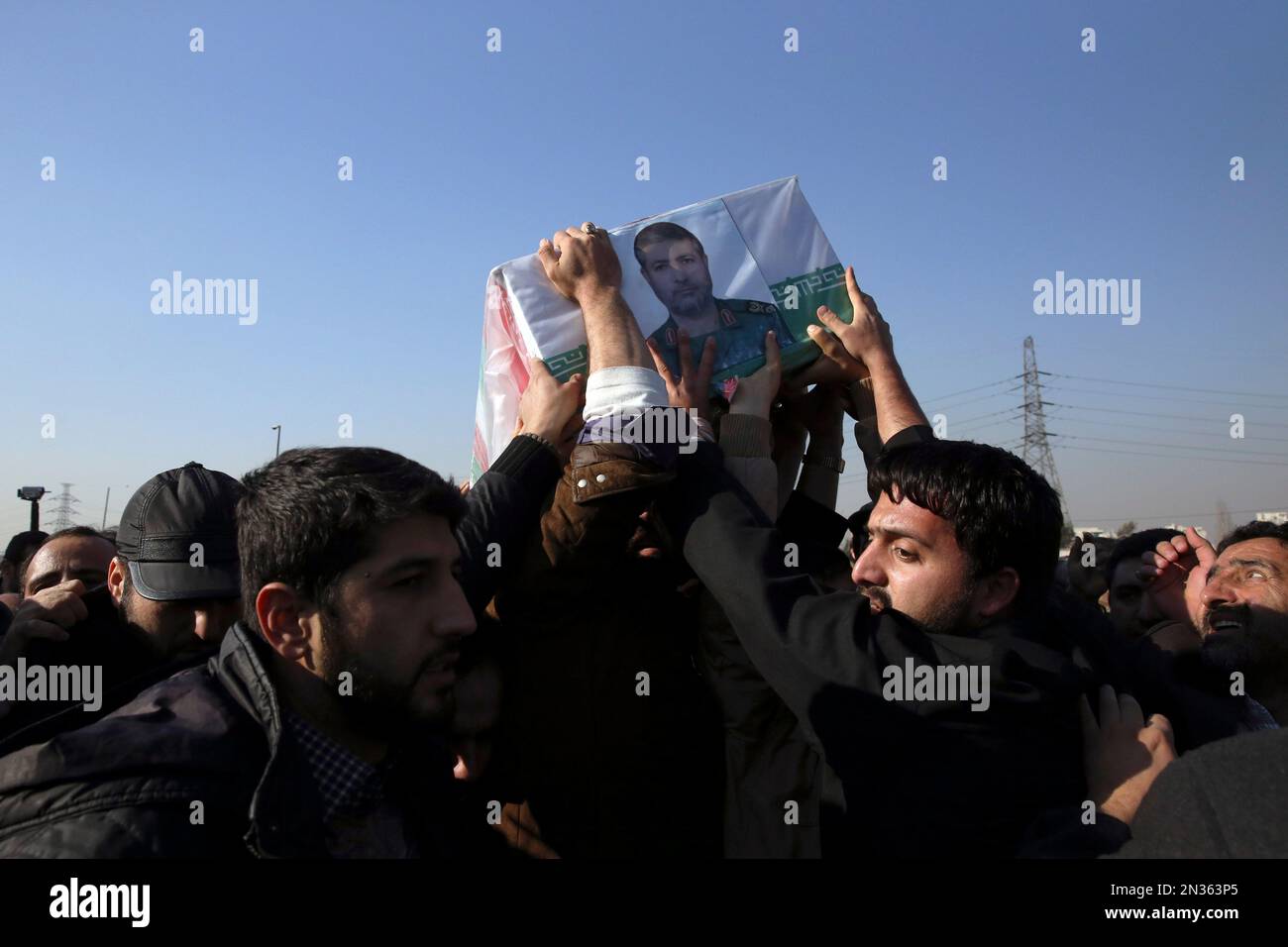 Civilians and armed forces members carry the coffin of Iranian ...