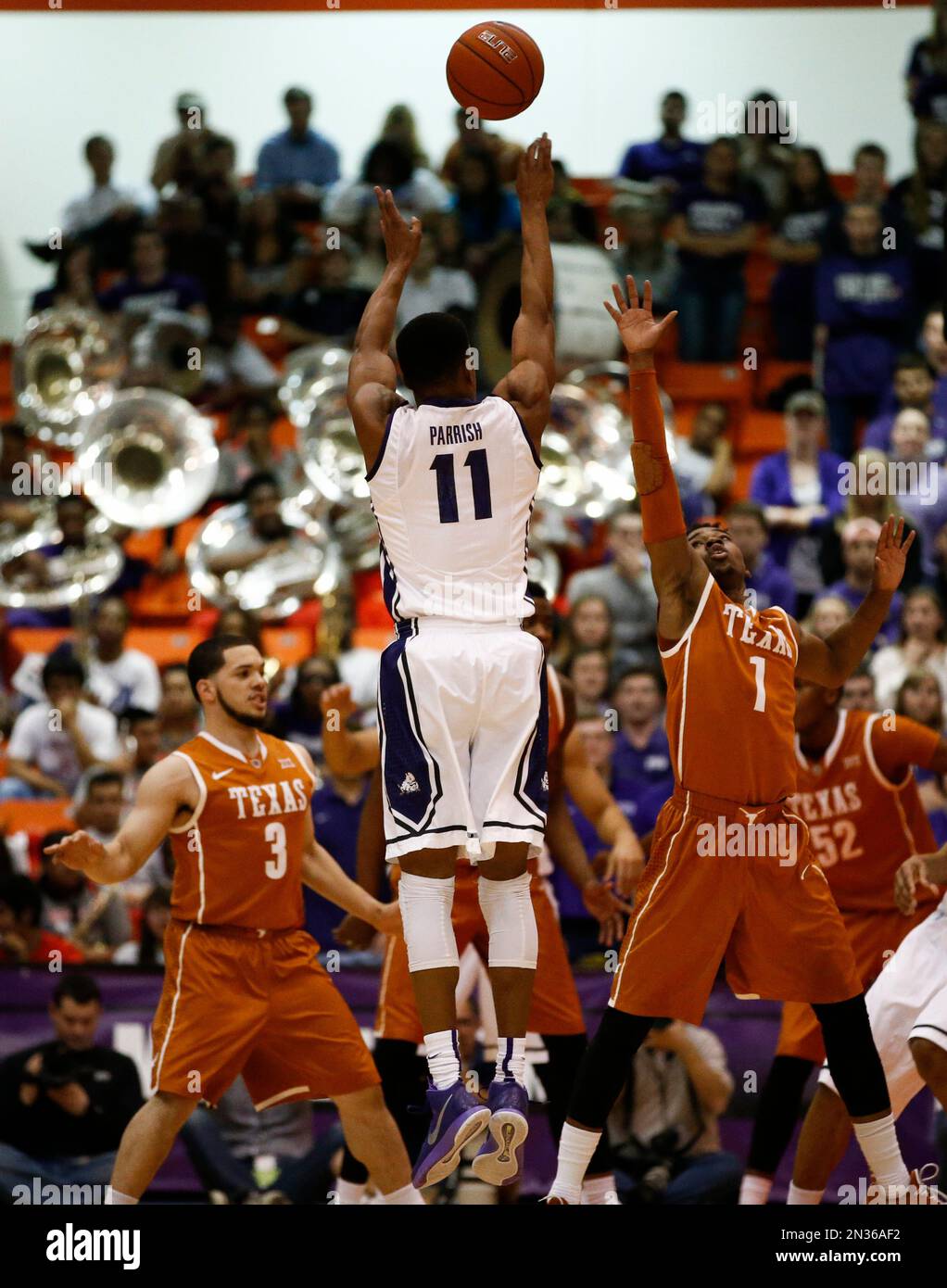 TCU forward Brandon Parrish (11) shoots the ball over Texas guard ...