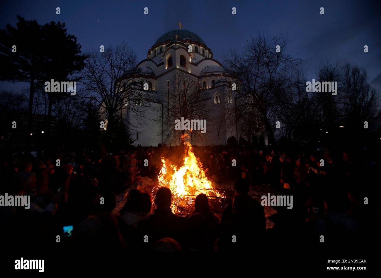 People watch a ceremonial burning of dried oak branches - the Yule log ...