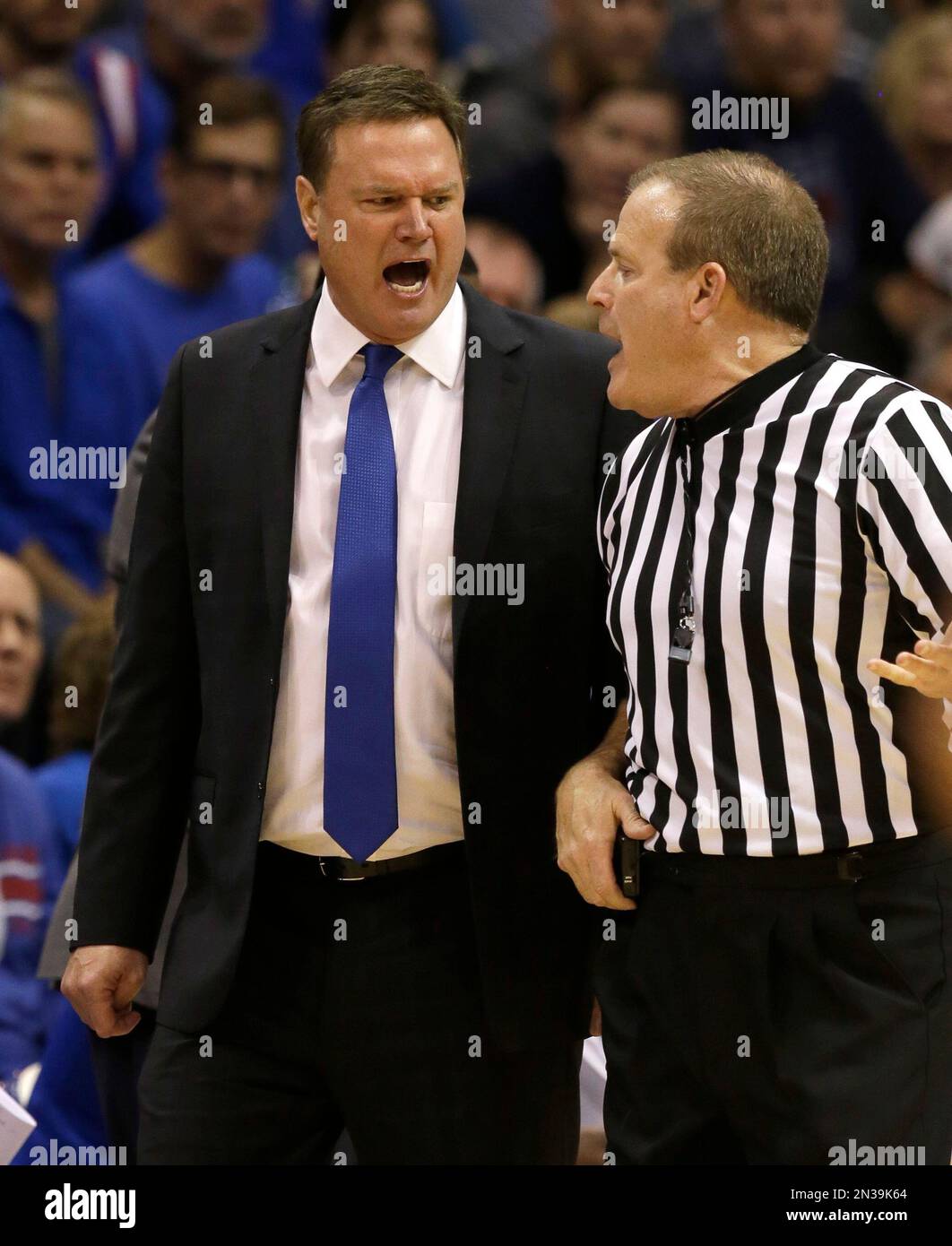 Kansas head coach Bill Self, left, has words with referee Gerry Pollard ...