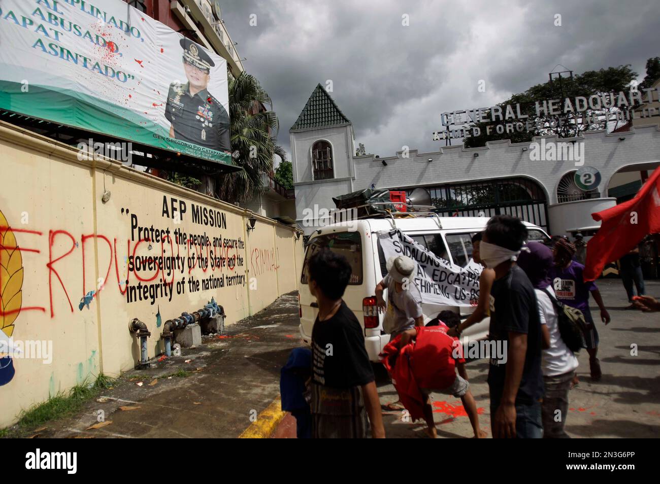 Filipino protesters throw paint on a poster showing Philippine military ...