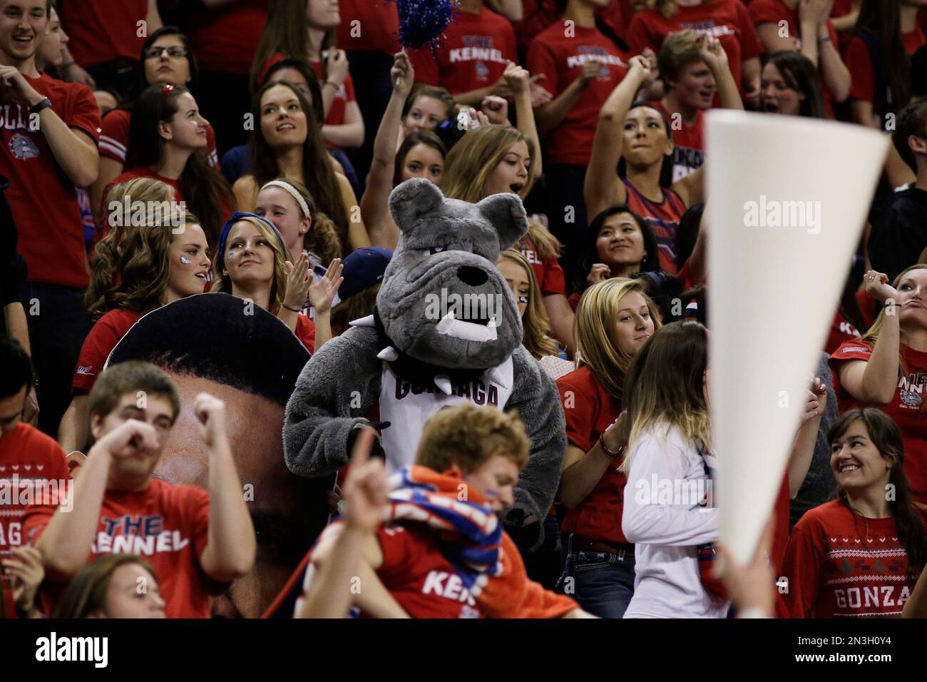 Gonzaga's mascot, center, stands with fans in the student section ...
