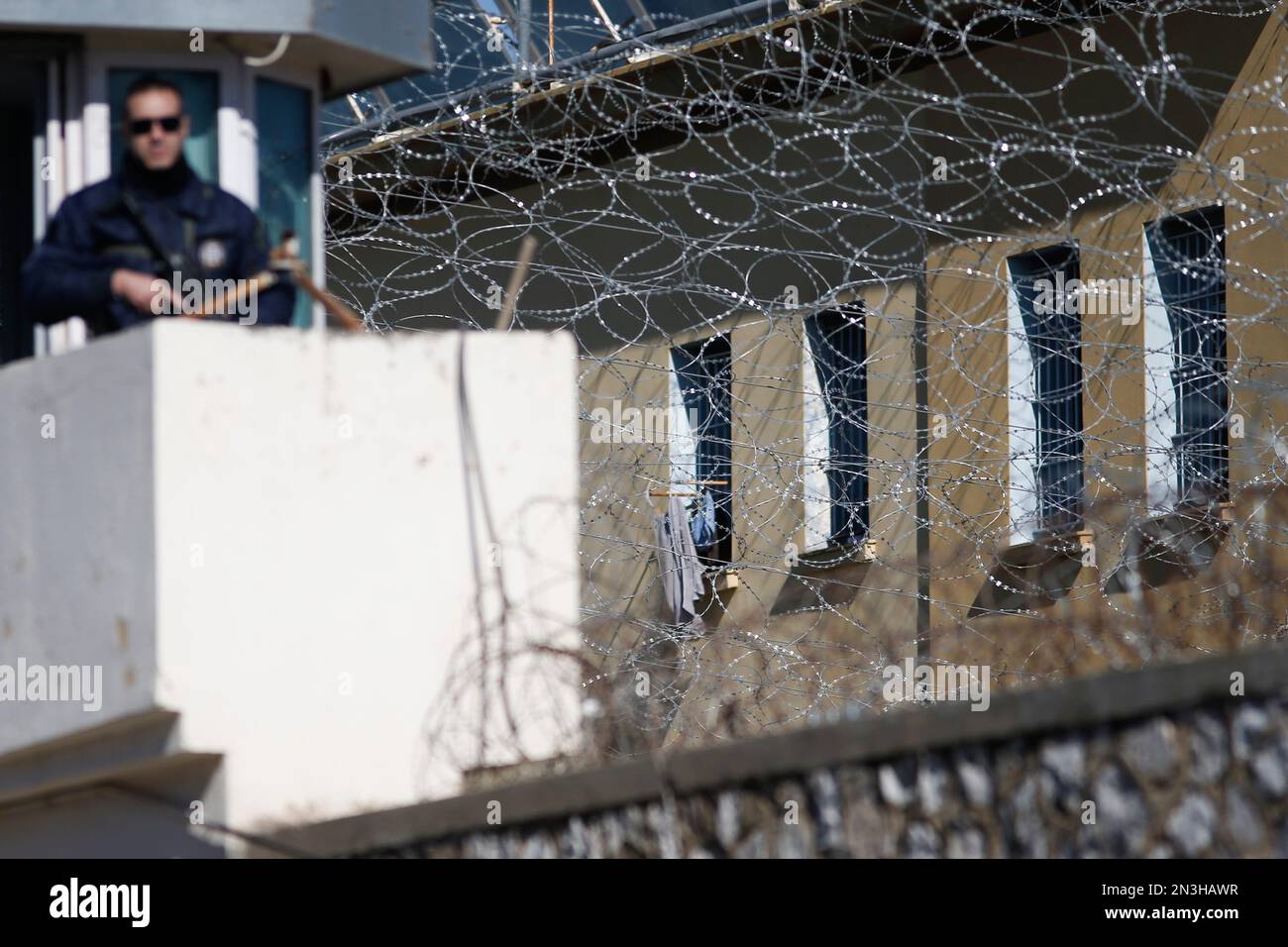A police officer stands guard at Korydallos Prison, in western Athens ...