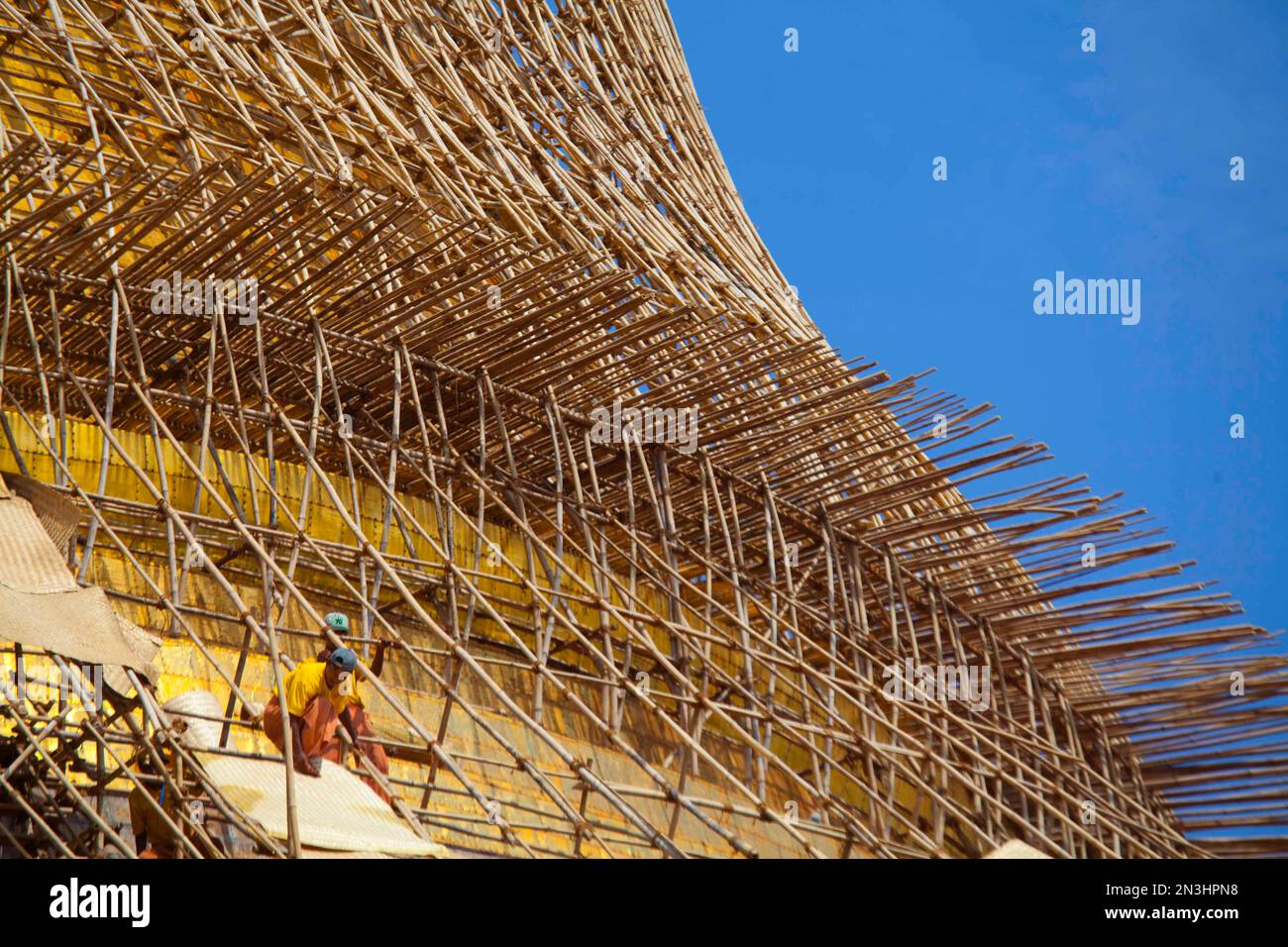 In this photo taken on Nov. 3, 2014, workers put mats on bamboo ...