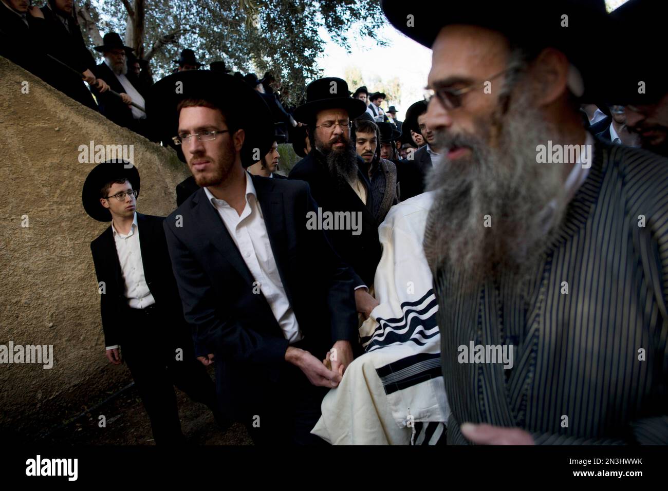 Ultra-Orthodox Jews carry the body of Mosheh Twersky during his funeral ...