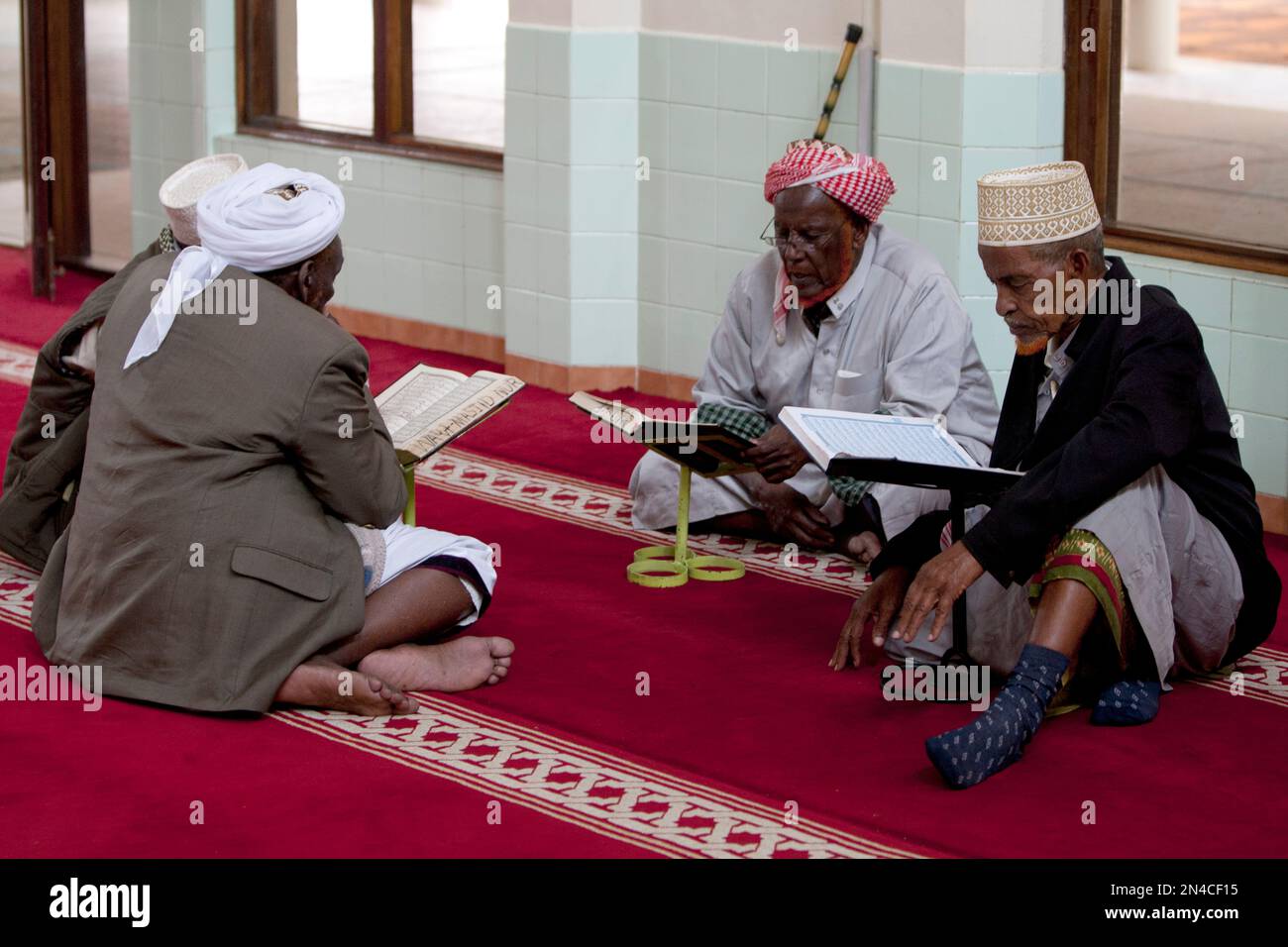 Kenyan Muslims recite the Holy Quran after prayers at the Noor Masjid ...