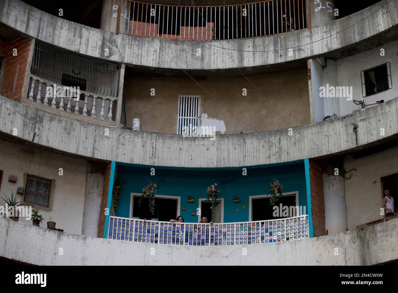 A couple sits on the balcony of their apartment at the the world’s ...