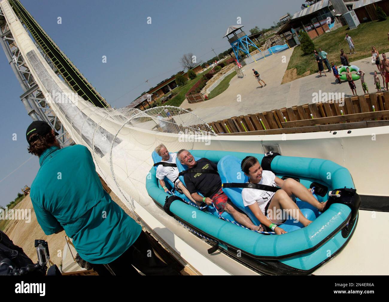 Ride designer Jeff Henry, left, watches as people ride his creation ...