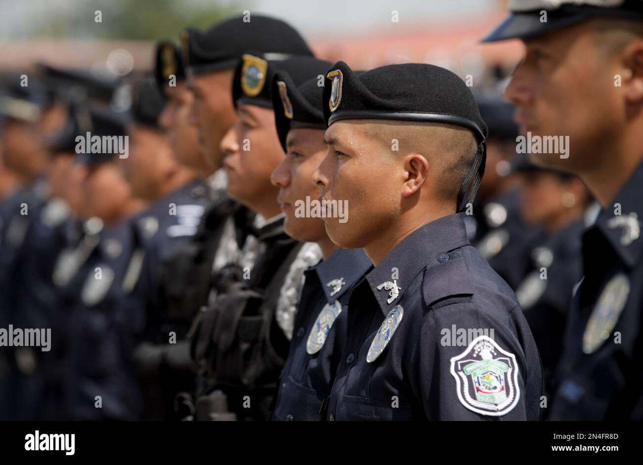 National police agents stand guard during a change of command ceremony ...