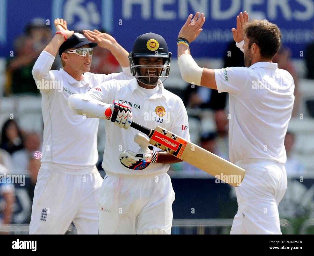 England's Liam Plunkett, right, and Joe Root celebrate as Sri Lanka's ...