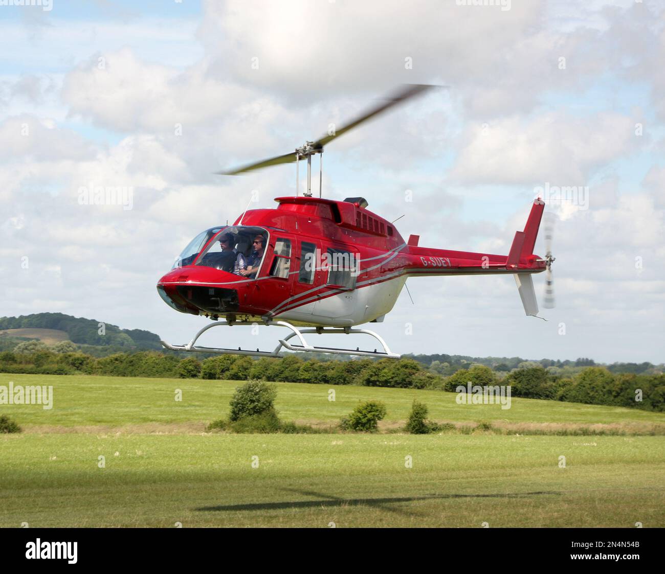 Un hélicoptère Bell 206L-1 LongRanger vole le long de la piste dans un ...