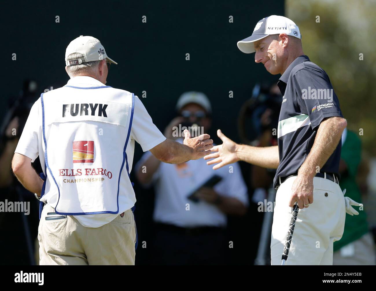 Jim Furyk, right, shakes hands with his caddie, Mike 'Fluff' Cowan ...