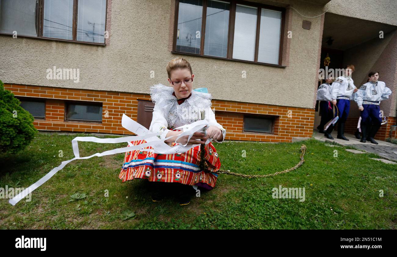 Kristyna Horenska ties a ribbon after being whipped symbolically by a ...