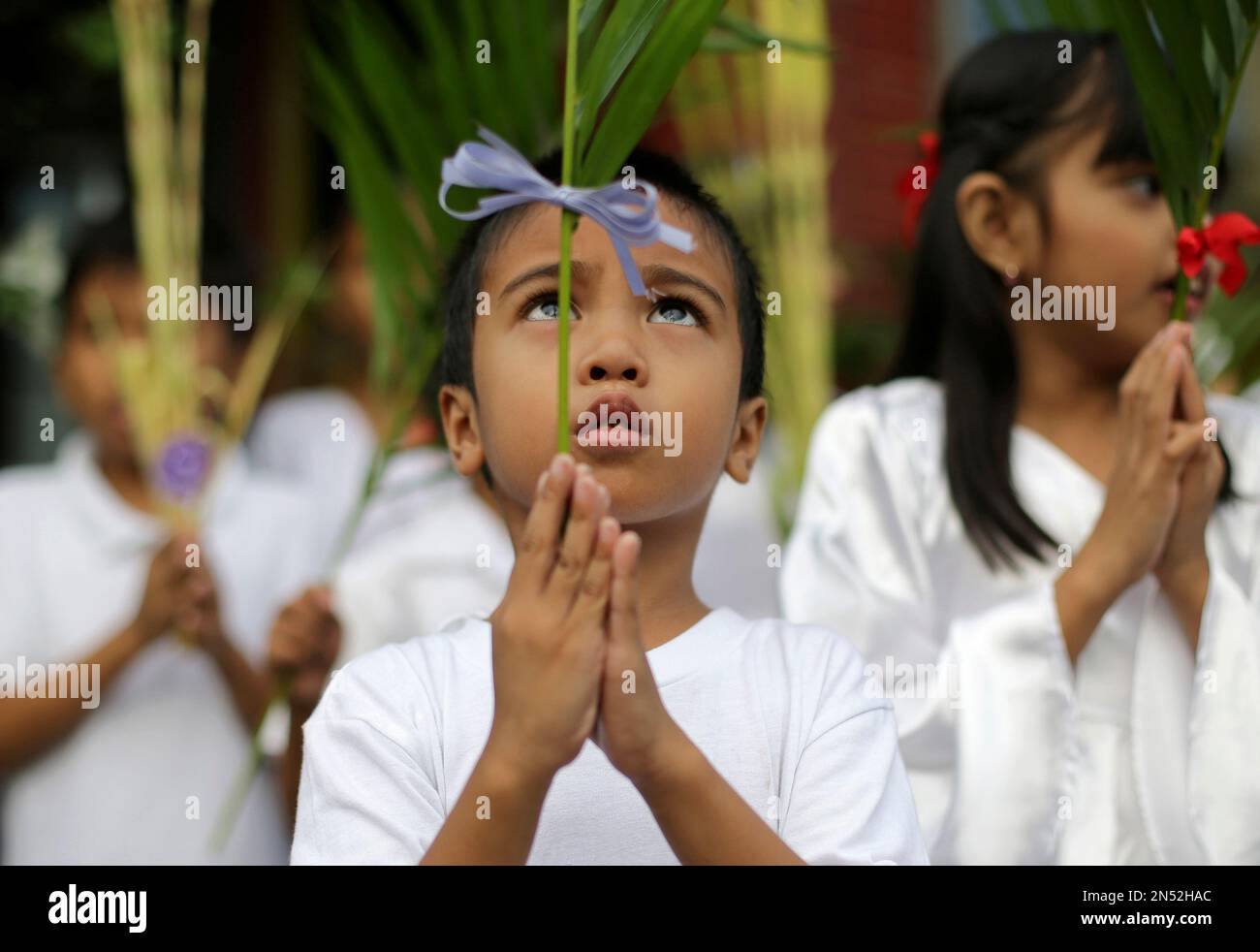A Filipino boy participates in Palm Sunday rites outside the Holy ...