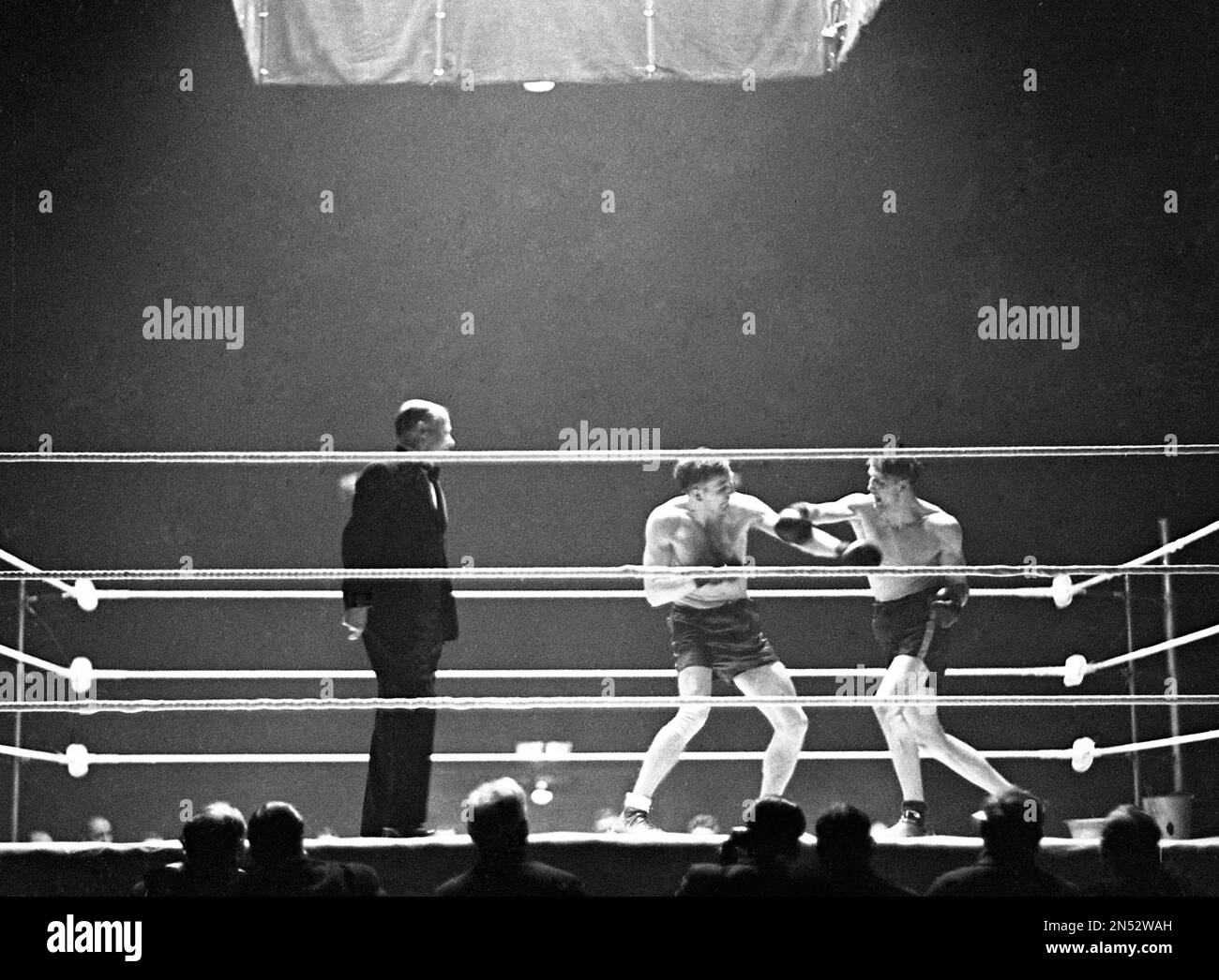 Britain's Jack Petersen, right, misses with a hard right to the head of Germany's Walter Neusel ...