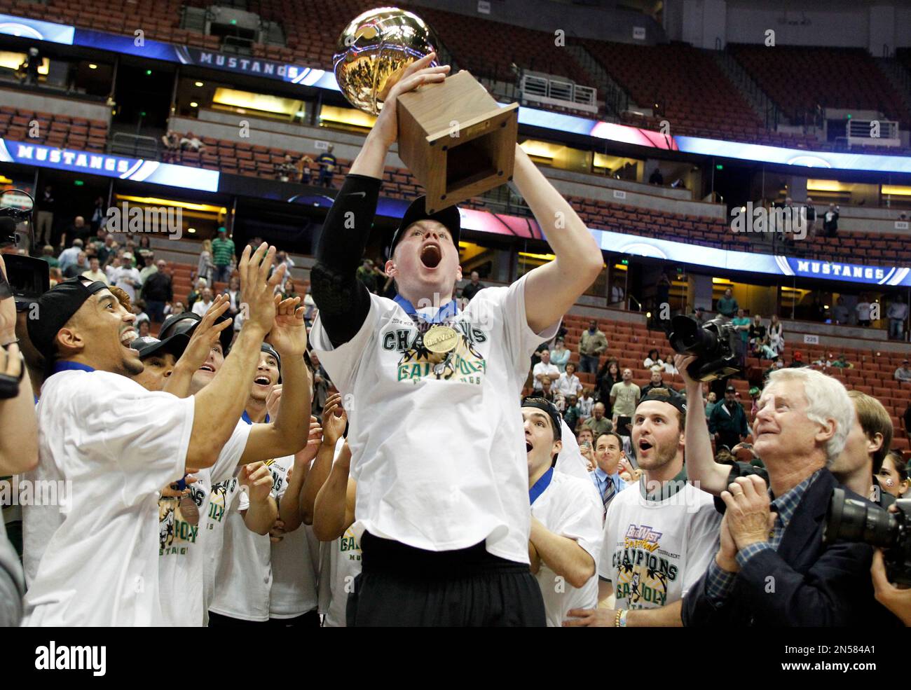 Cal Poly forward Zach Gordon, center, catches the trophy thrown to him ...