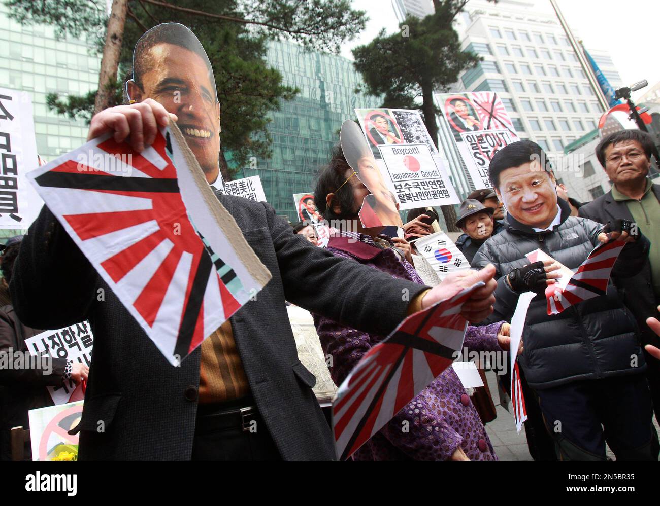 Protester wearing masks of U.S. President Barack Obama, left, South ...