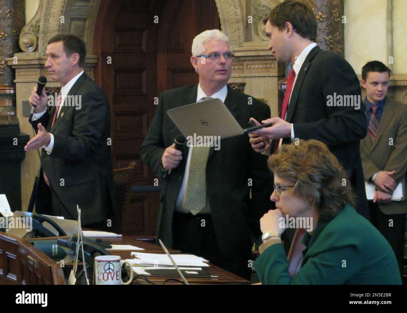 Kansas state Senator's Garrett Love, right and Pat Apple, center, talk ...