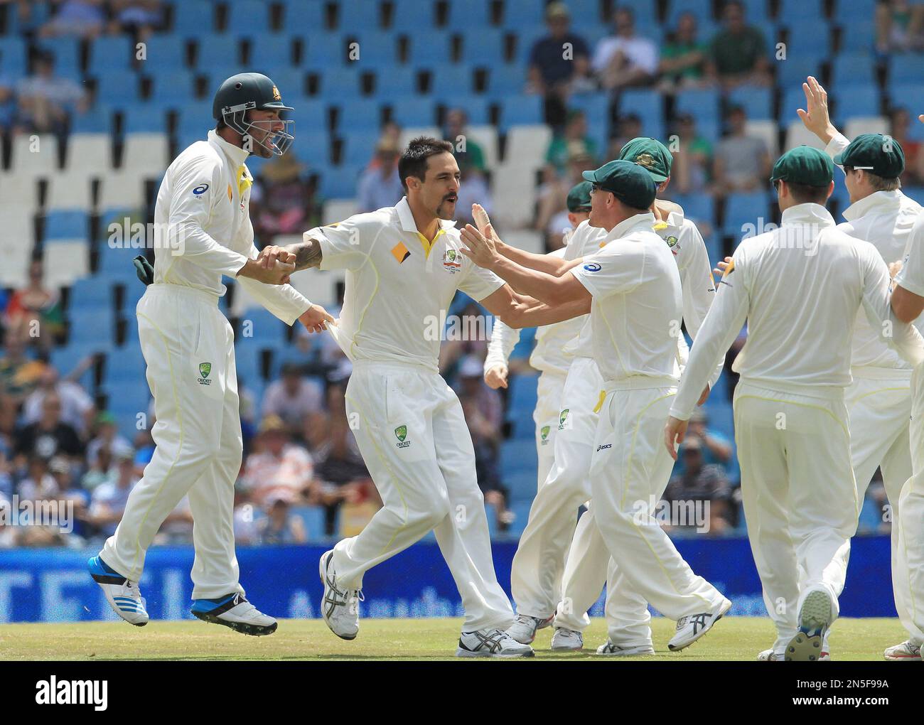 Australia's bowler Mitchell Johnson, second from left, celebrates with ...