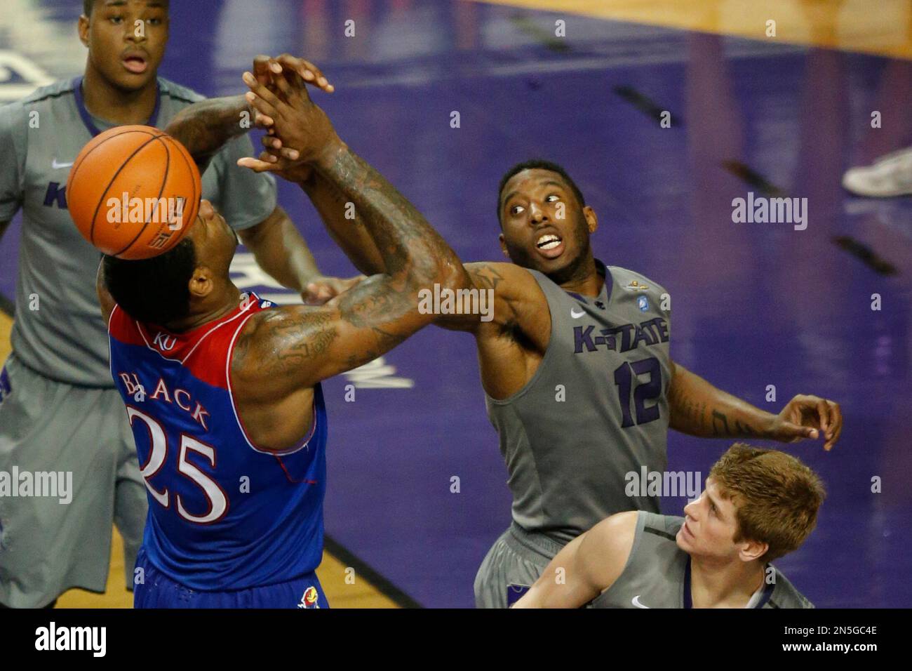Kansas State guard Omari Lawrence (12) blocks a shot by Kansas forward ...