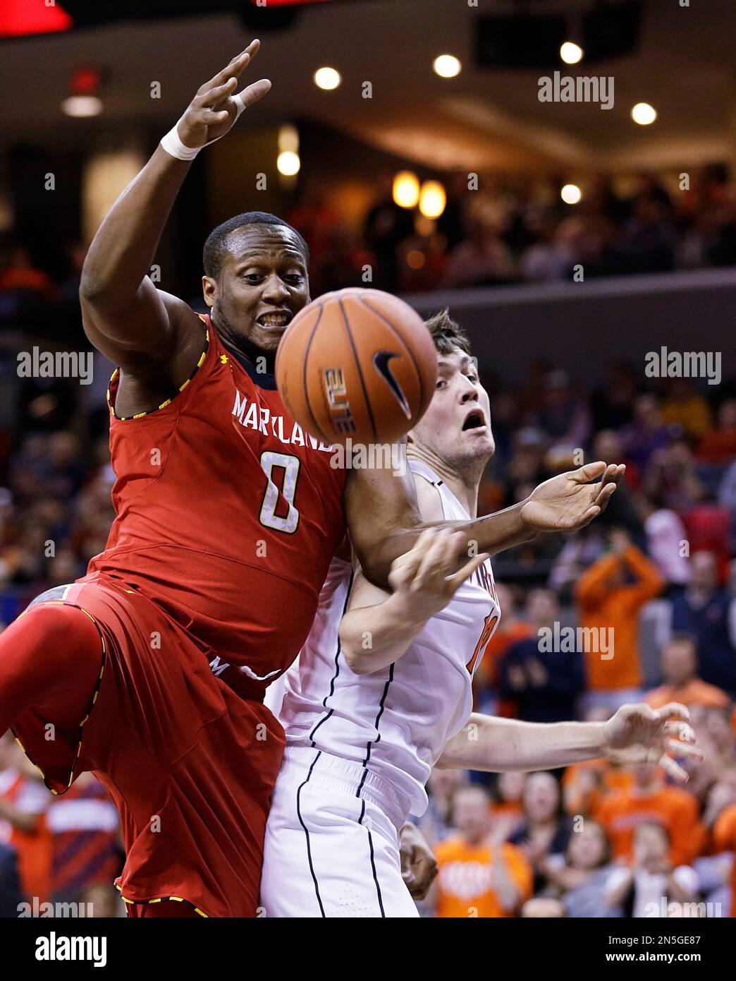 Maryland forward Charles Mitchell (0) goes for a rebound with Virginia ...