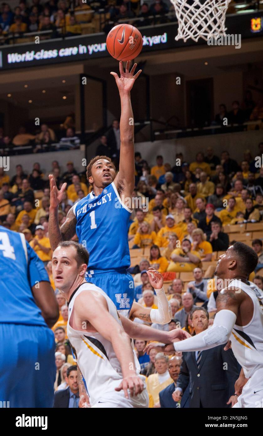 Kentucky's James Young, top, shoots over Missouri's Ryan Rosburg, left ...