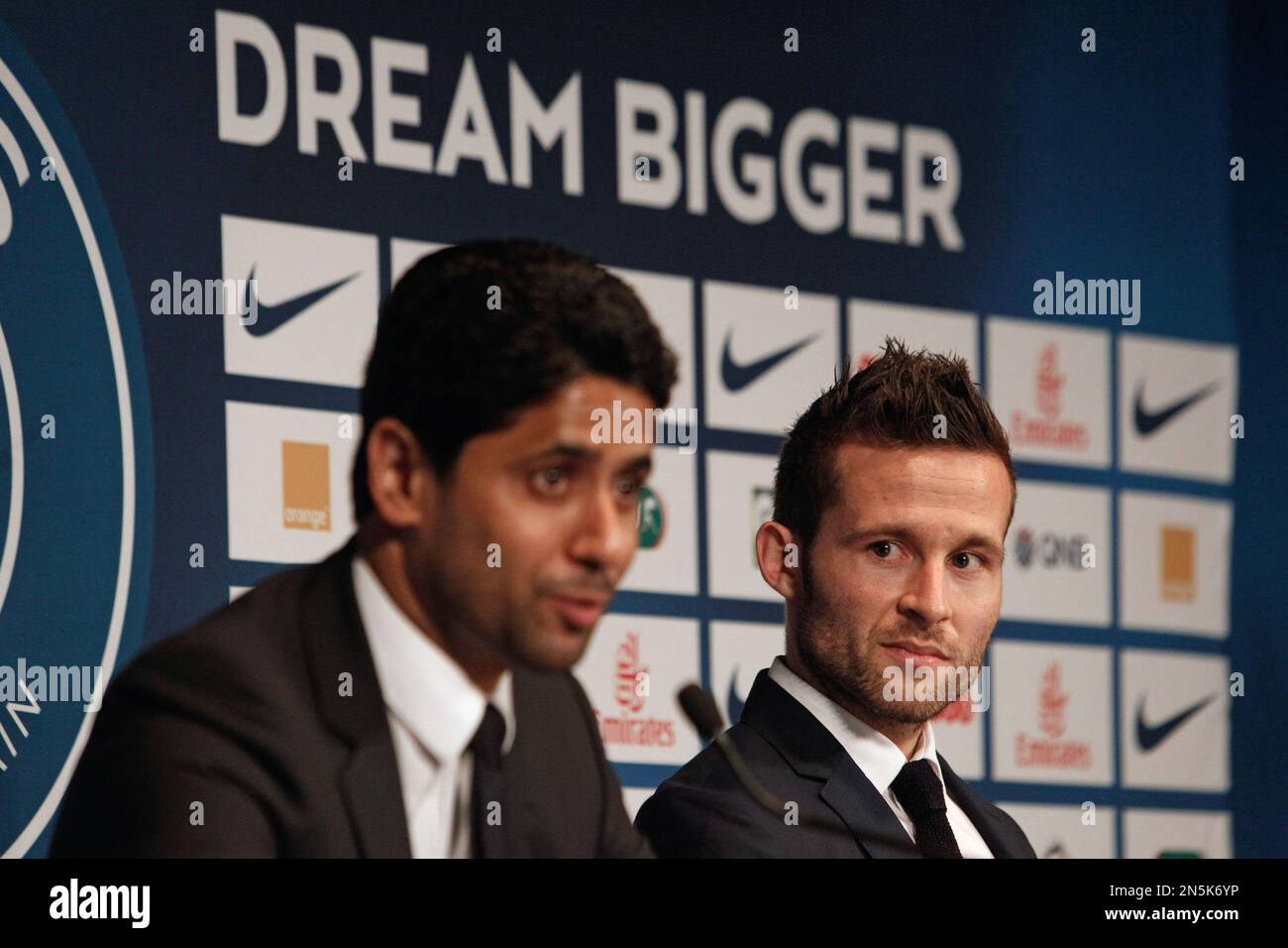 Soccer player Yohan Cabaye, right, and PSG President Nasser al-Khelaifi ...