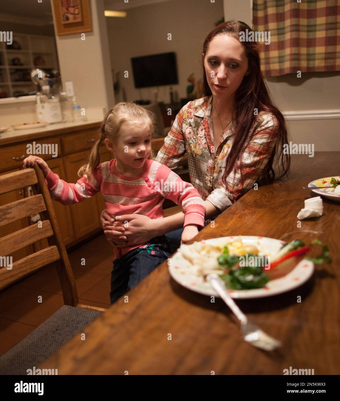Maggie Barcellano sits down for dinner with her daughter, Zoe, 3, at ...