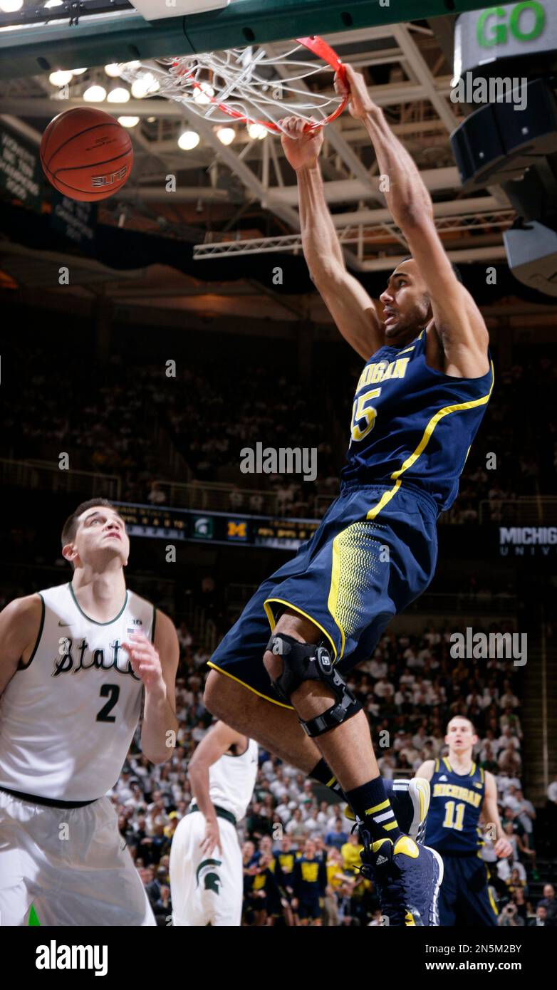 Michigan's Jon Horford, right, dunks against Michigan State's Alex ...