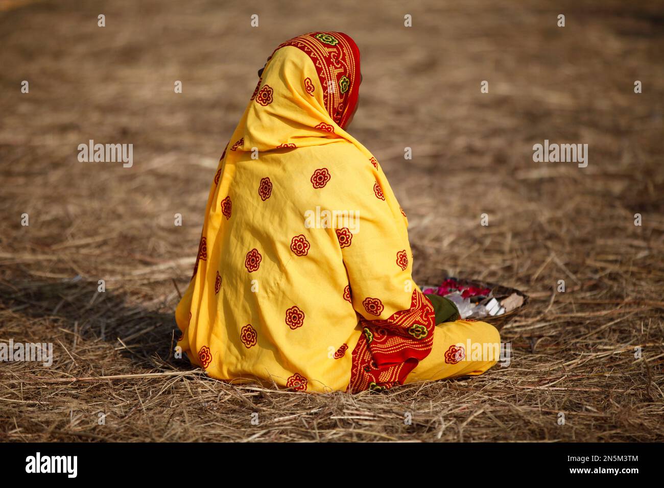 An Indian vendor woman waits for Hindu devotees to selling offering ...