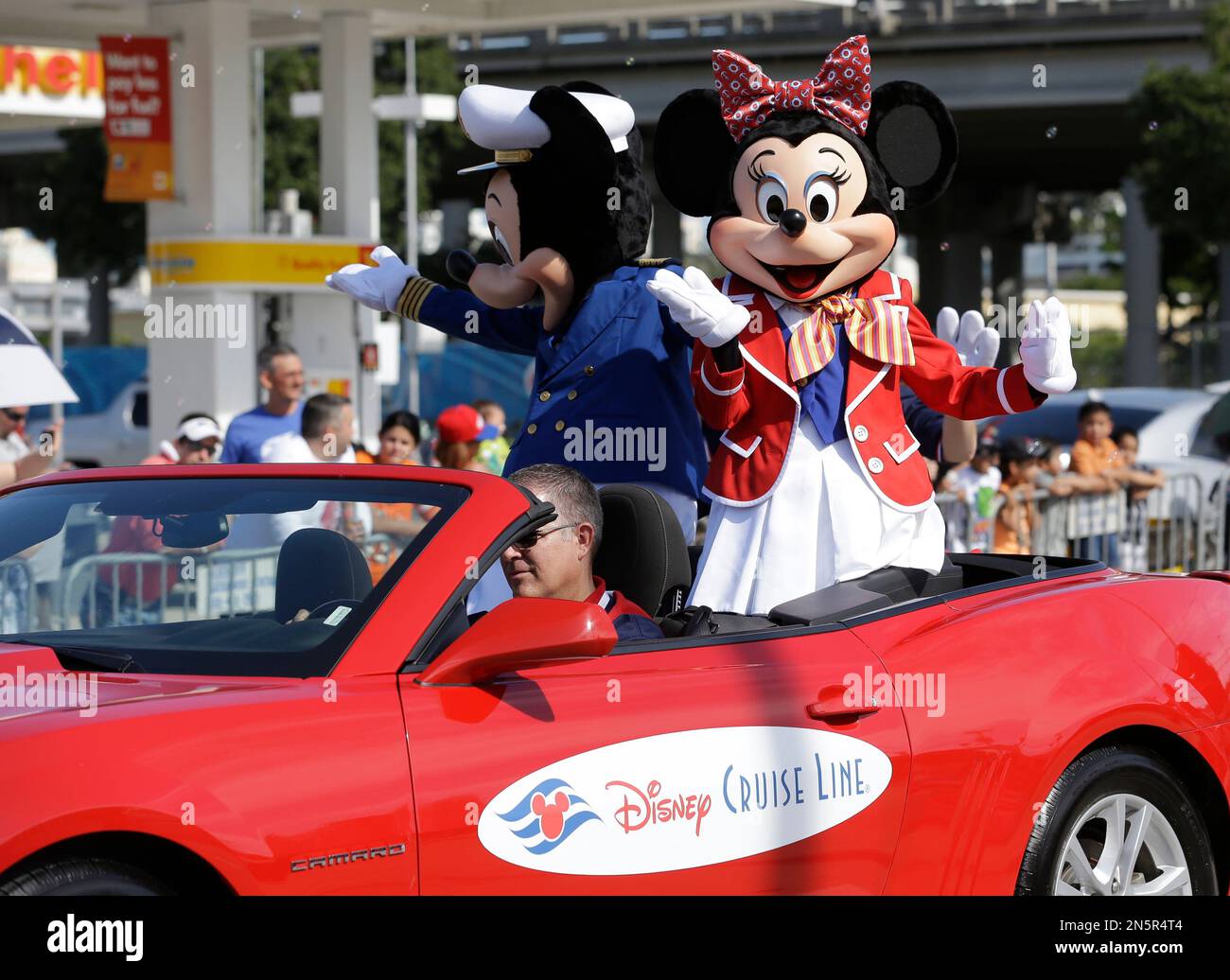 Disney characters Minnie Mouse, right, and Mickey Mouse, rear, ride in ...