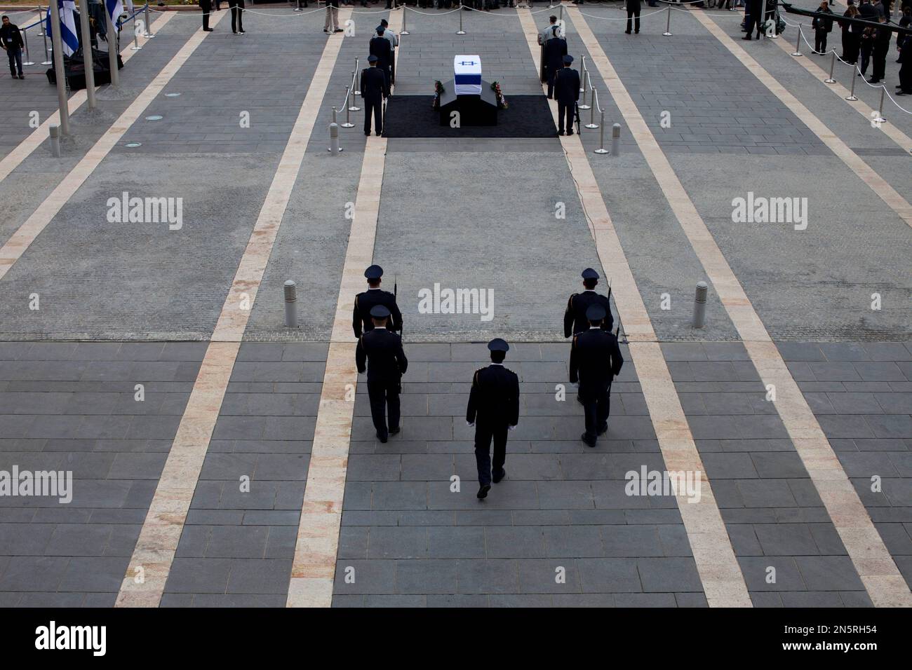 Members of the Knesset guard form an honor guard around the coffin of ...