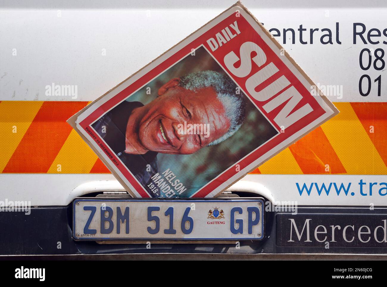 A placard showing the face of Nelson Mandela is wedged into the rear ...