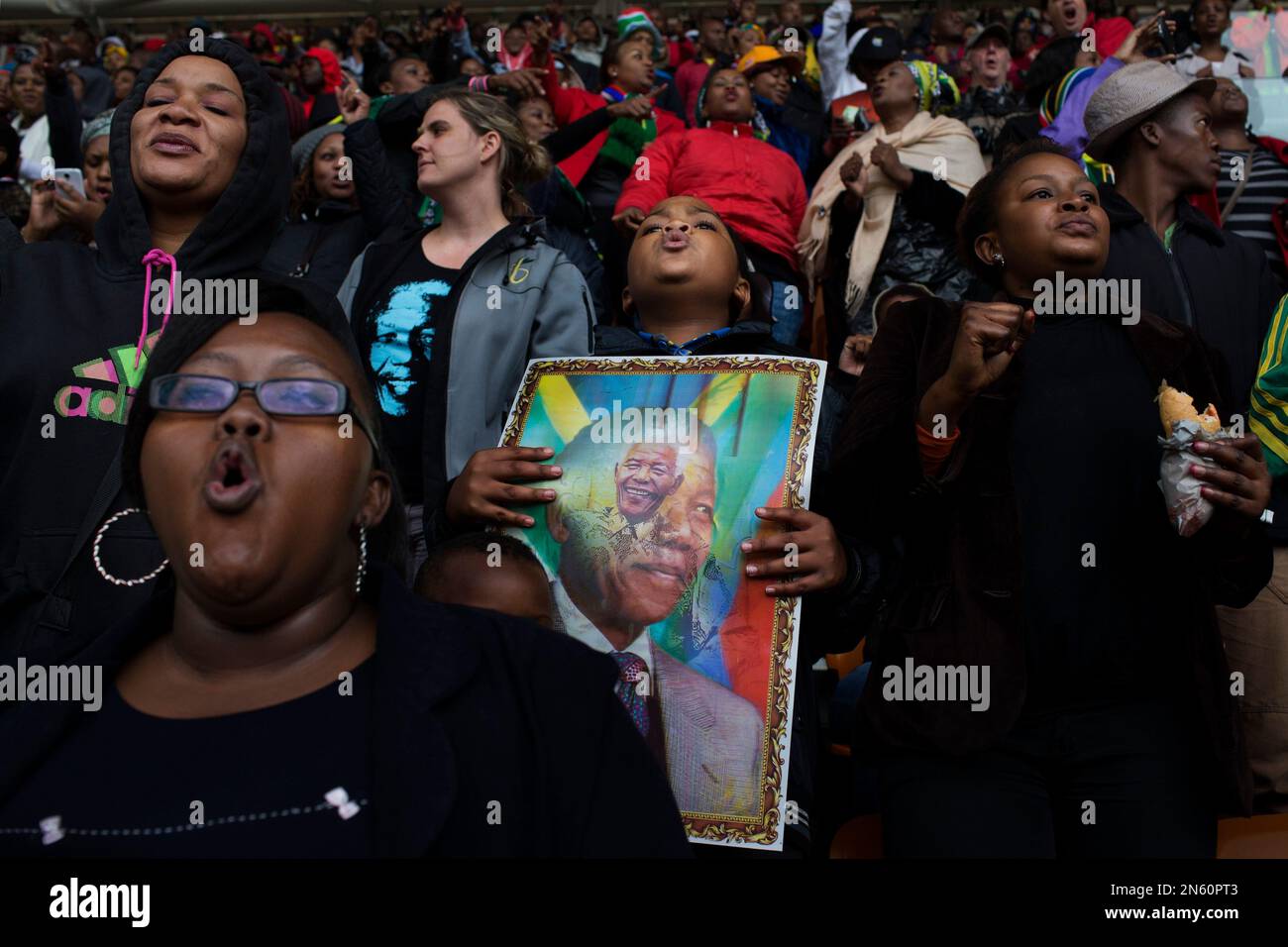 People shout out and hold posters during the memorial service for ...
