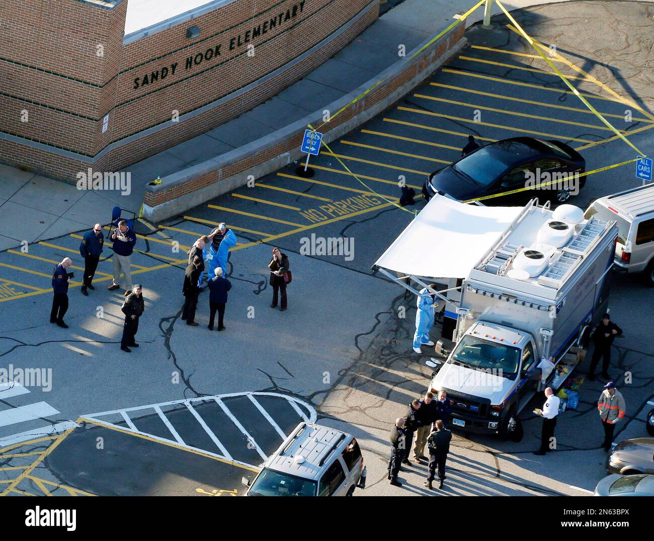 FILE - In this Dec. 14, 2012 aerial file photo, officials stand outside of Sandy Hook Elementary ...